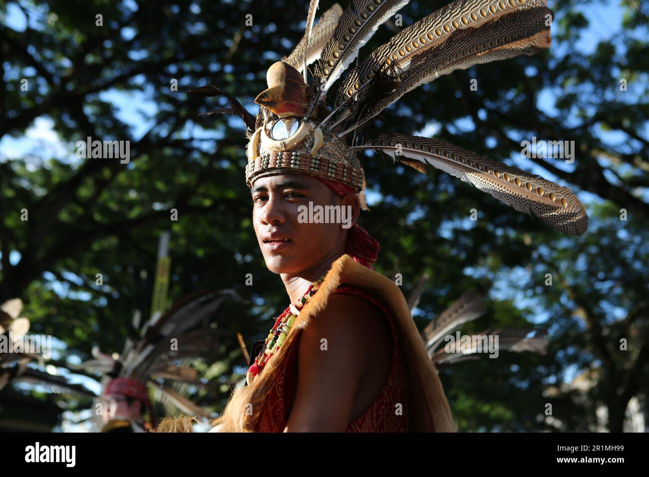 A young warrior in traditional outfit in Kuching, Sarawak, Malaysia ...