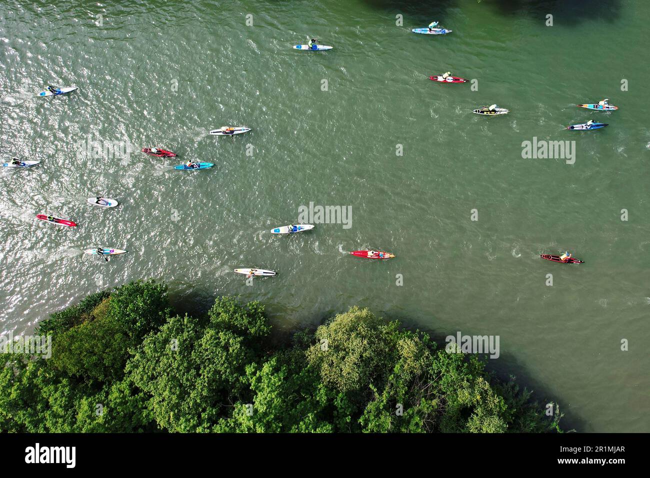 Contestants compete in a competition of standup paddling and kayaking ...