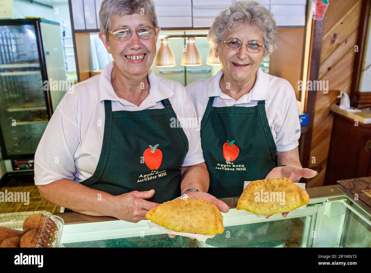 Inside interior woman women employees workers holding apple pastry hi ...