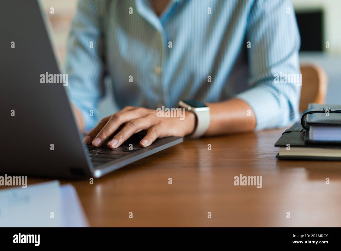 Close up hands of businesswoman typing data on laptop keyboard while ...
