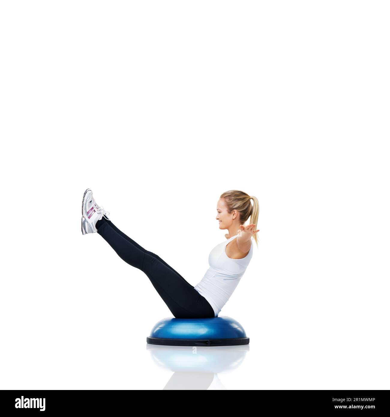 Shes increasing her core strength through balance. An attractive young ...