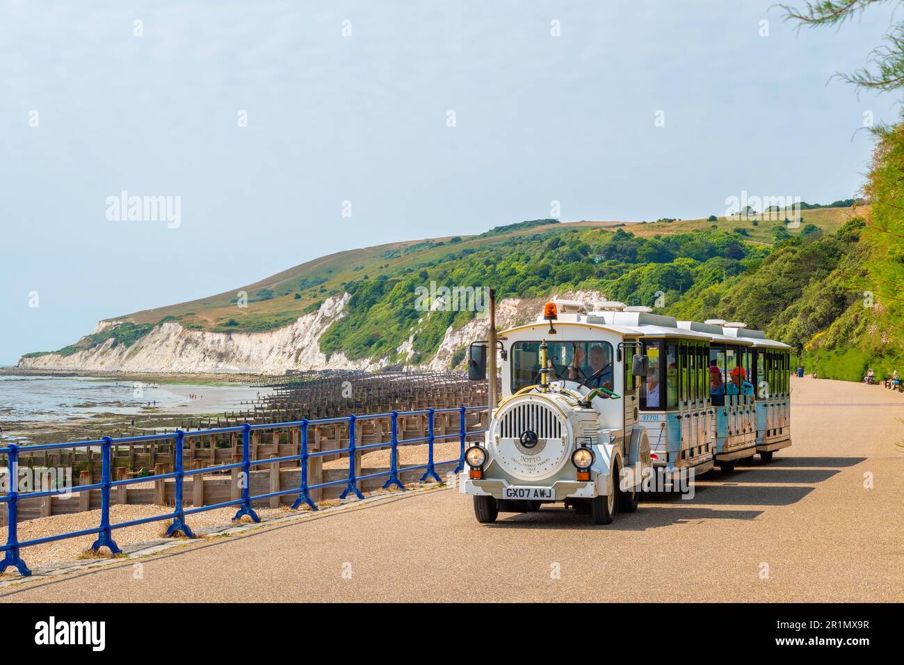 Sightseeing tourist tour train is riding along seaside promenade ...