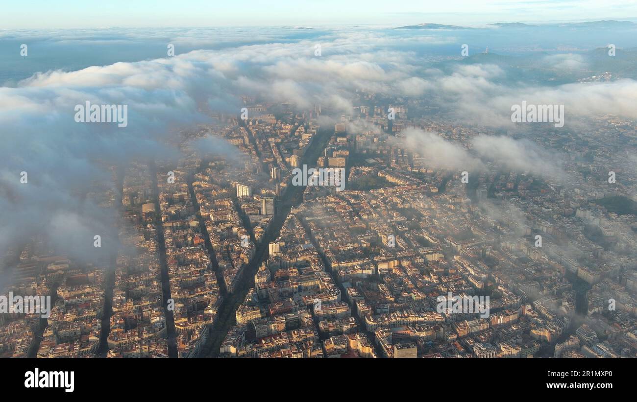 Aerial view of Barcelona City above the clouds and fog, typical buildings of Barcelona, Eixample ...