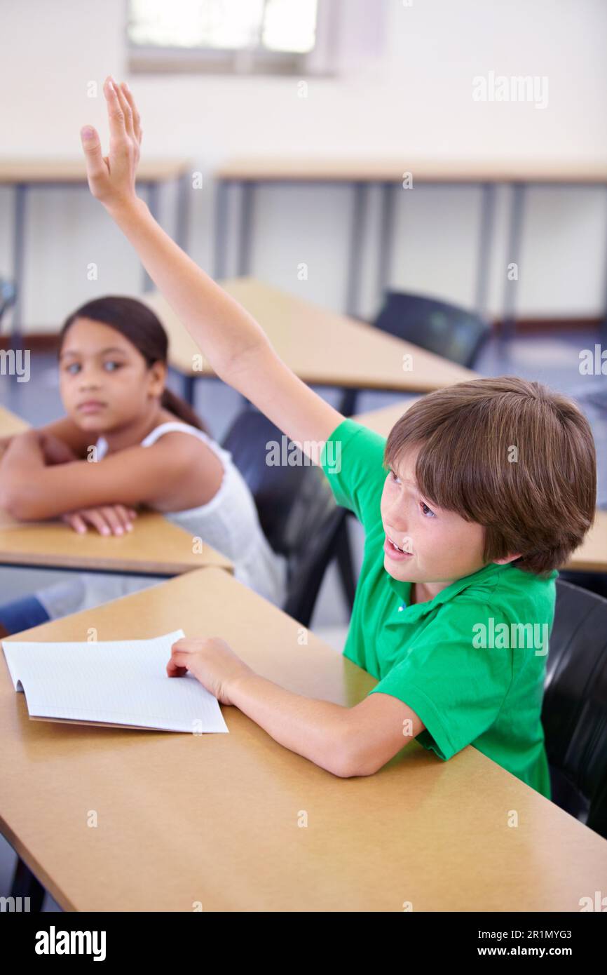 Child raise his hand in school for questions, support and help with ...