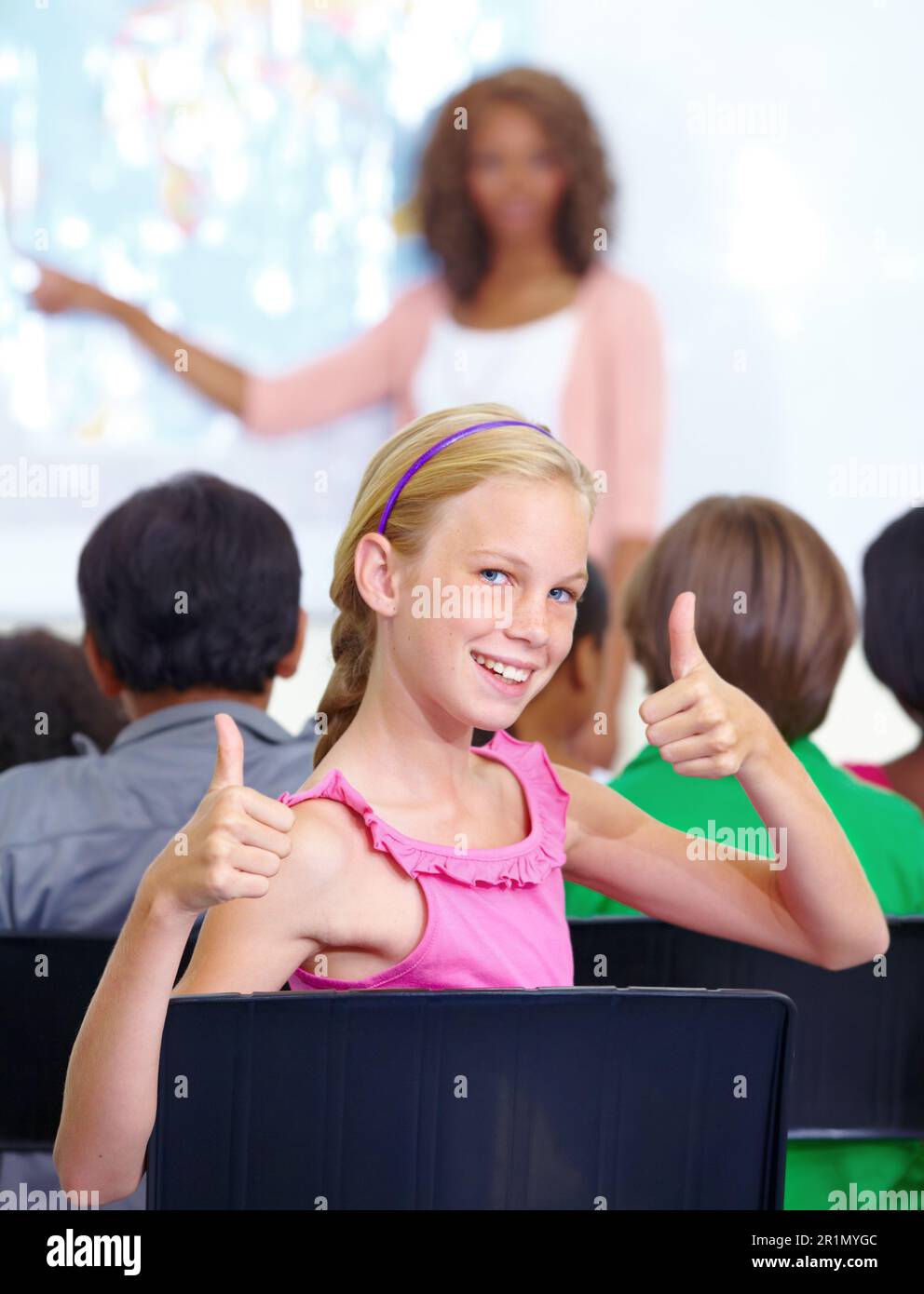Thumbs up, classroom and girl portrait for learning success, support ...