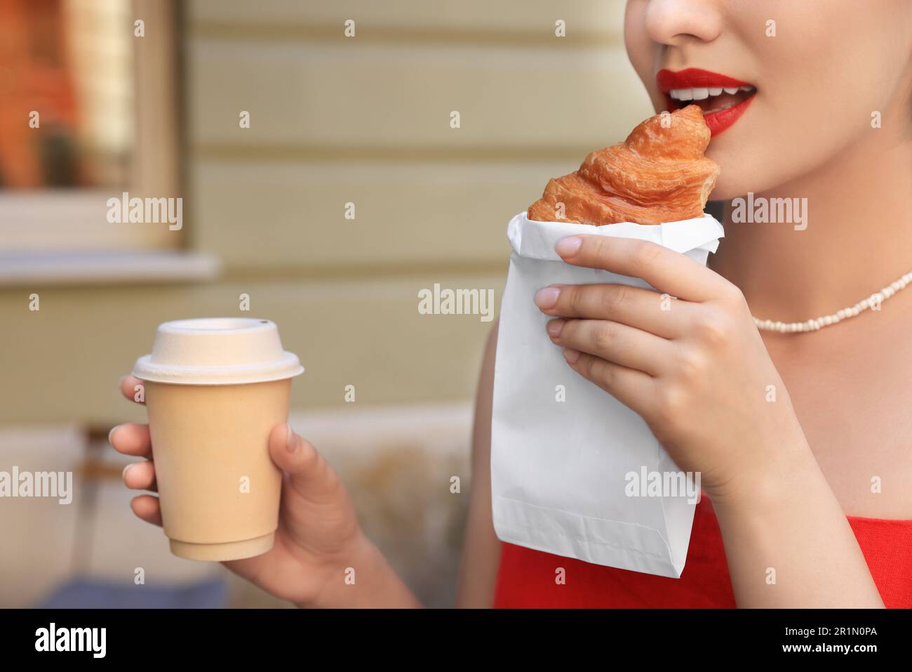 Woman eating croissant paper hi-res stock photography and images - Alamy