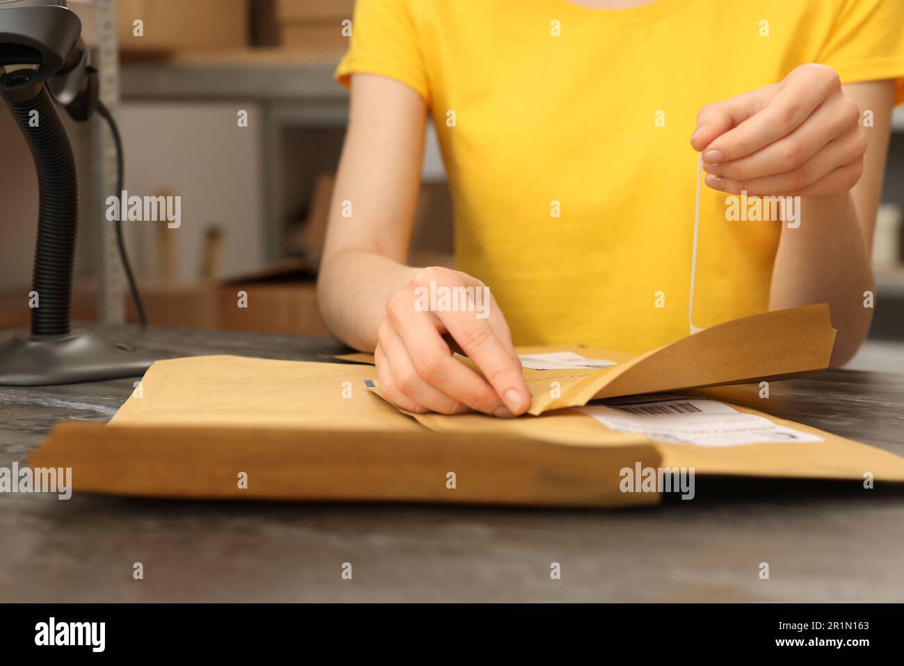 Post office worker with envelopes at counter indoors, closeup Stock ...