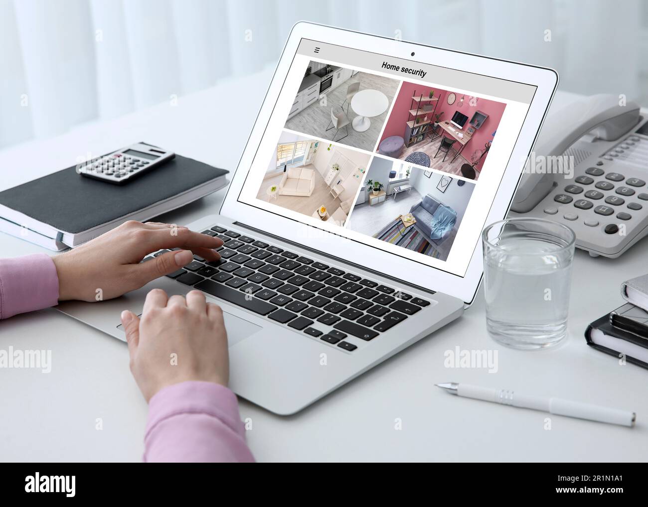 Woman monitoring CCTV cameras at table, closeup. Smart home security ...