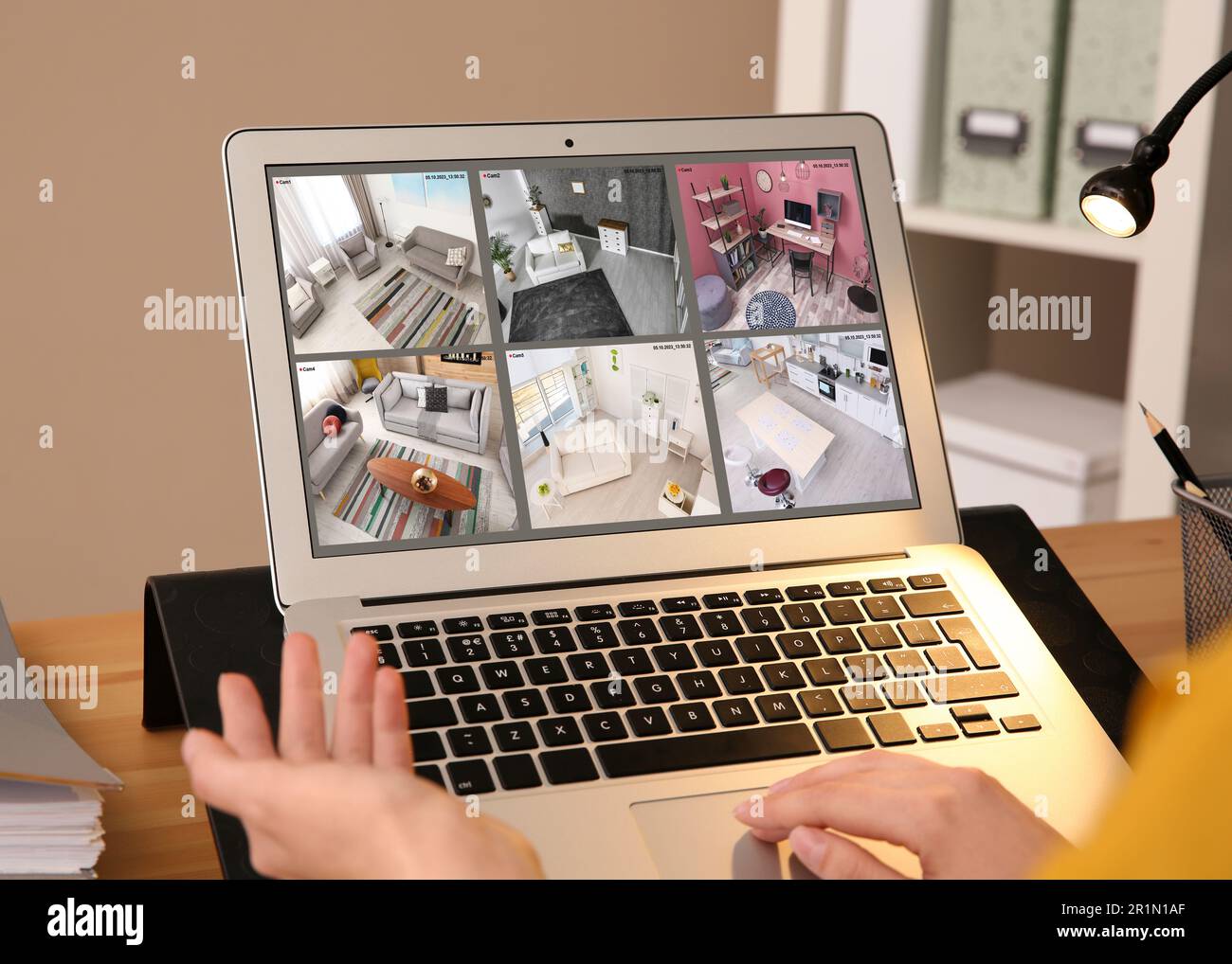 Woman monitoring CCTV cameras at table, closeup. Smart home security ...