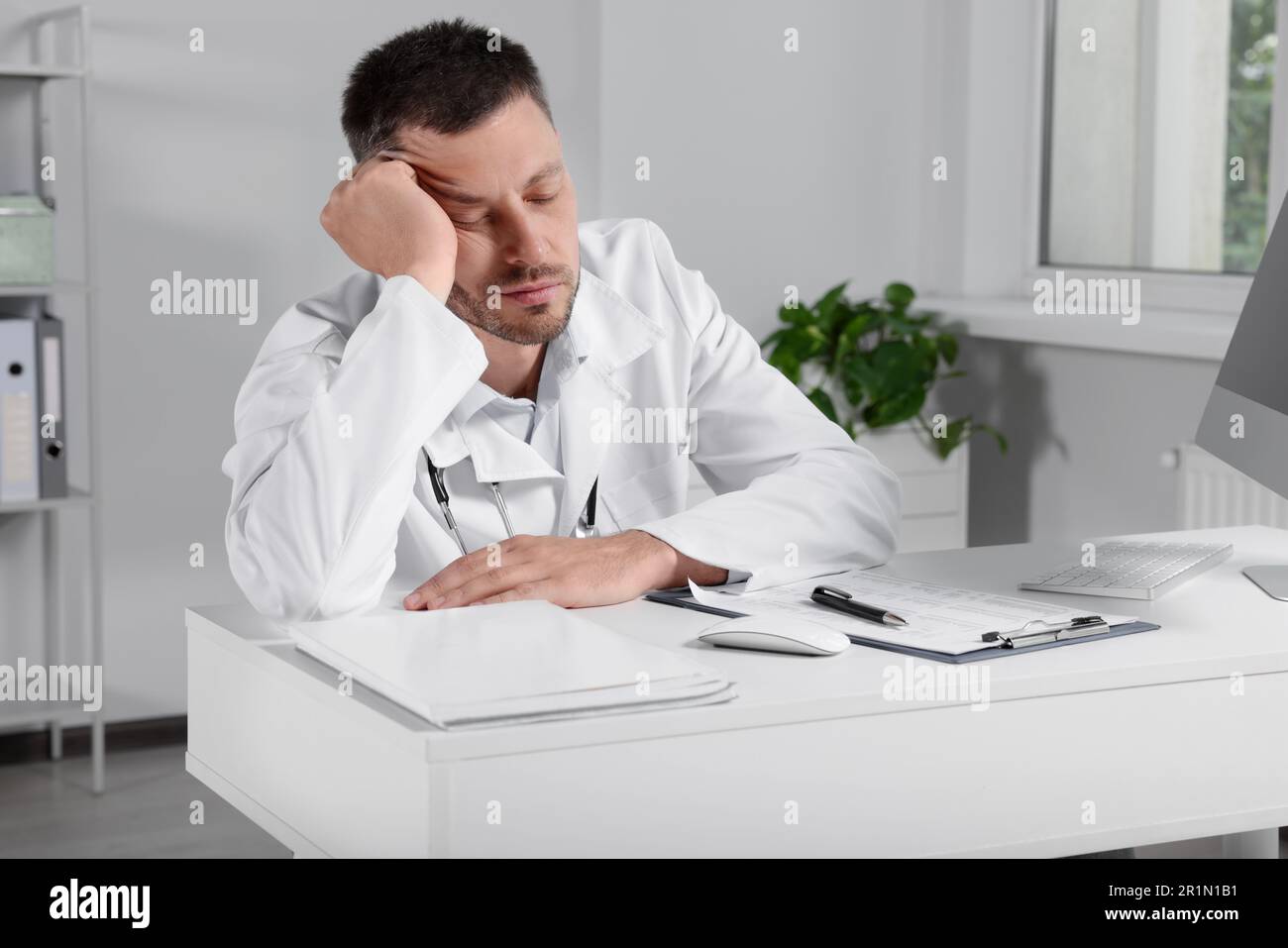 Exhausted doctor sleeping workplace hi-res stock photography and images ...