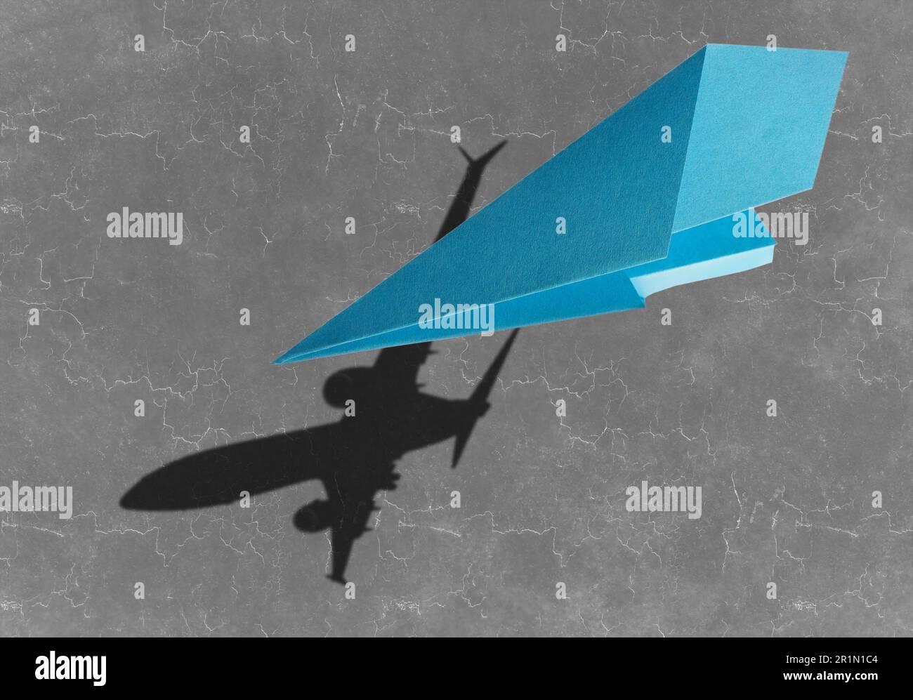 Flying paper plane and shadow of a real airplane on asphalt Stock Photo ...