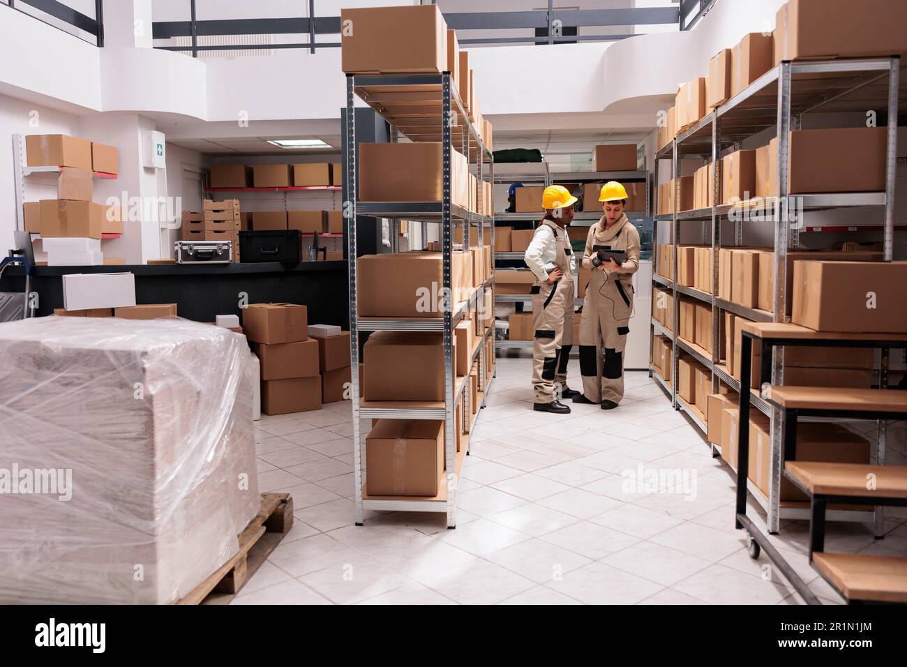 Warehouse employees scanning goods, tracking parcel in tablet software ...