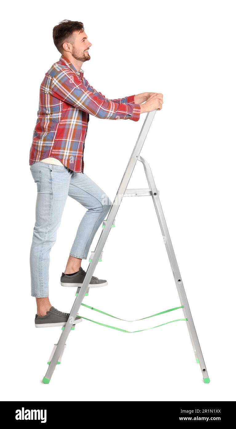 Young handsome man climbing up metal ladder on white background Stock ...
