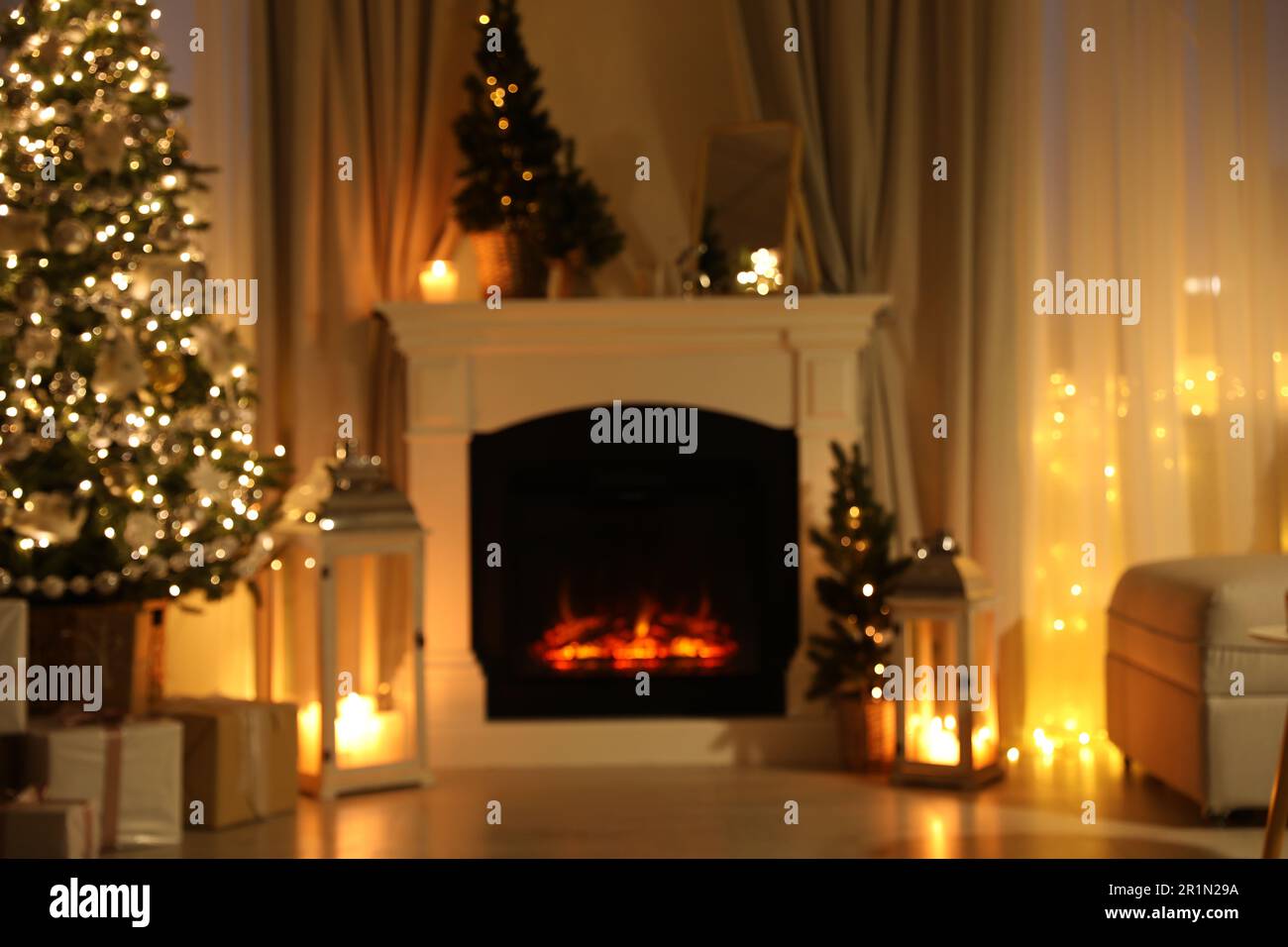 Beautiful fireplace, Christmas tree and other decorations in living ...