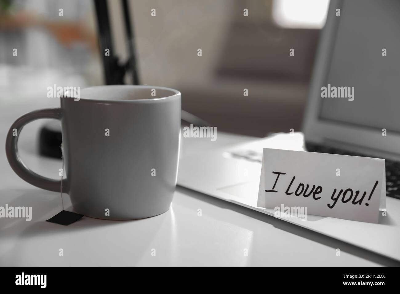 Note with handwritten text I Love You on workplace indoors. Romantic ...