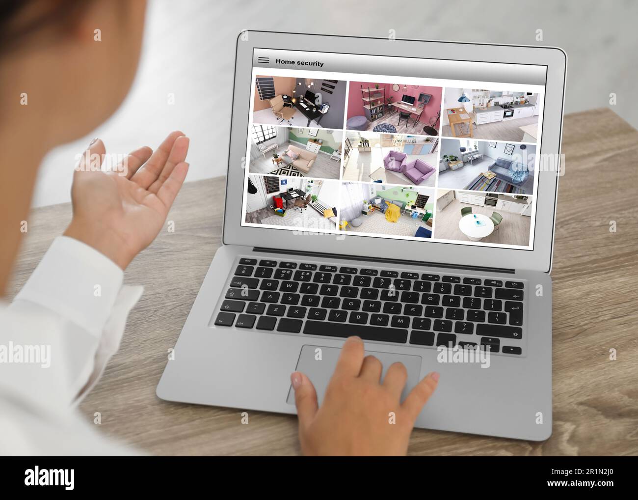 Woman monitoring CCTV cameras at table, closeup. Smart home security ...