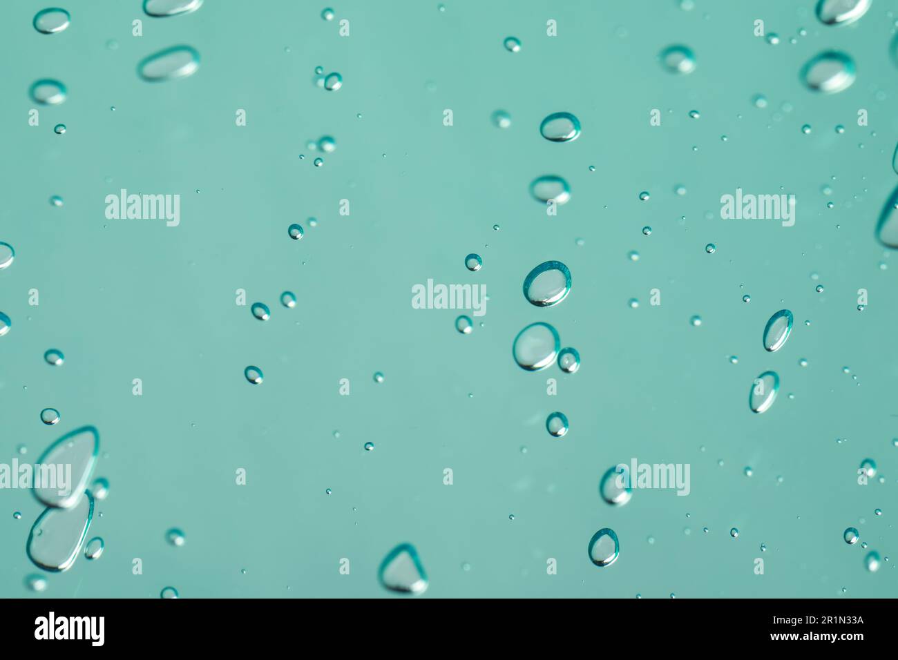 Serum drops on light blue background, closeup Stock Photo - Alamy