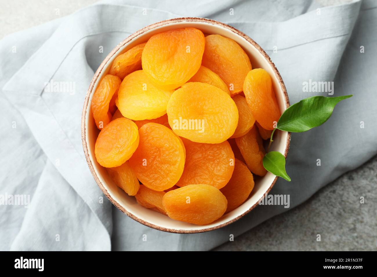 Bowl of tasty apricots on grey table, top view. Dried fruits Stock ...