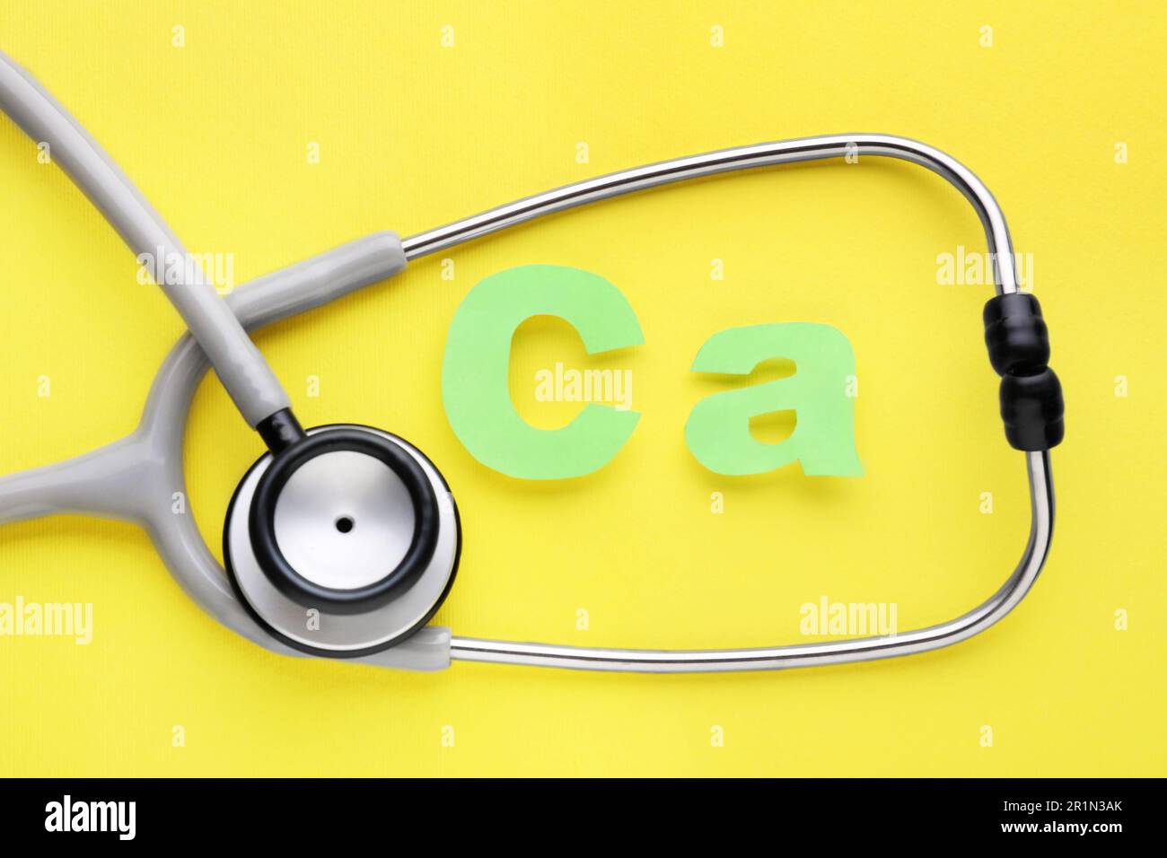 Stethoscope and calcium symbol made of green letters on yellow ...