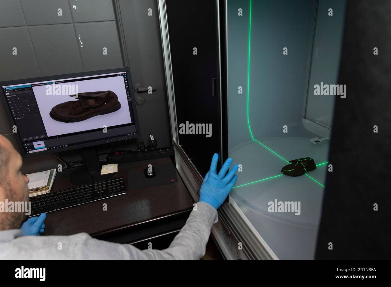 Miroslaw Maciaszczyk, a conservation specialist, scans a shoe that ...