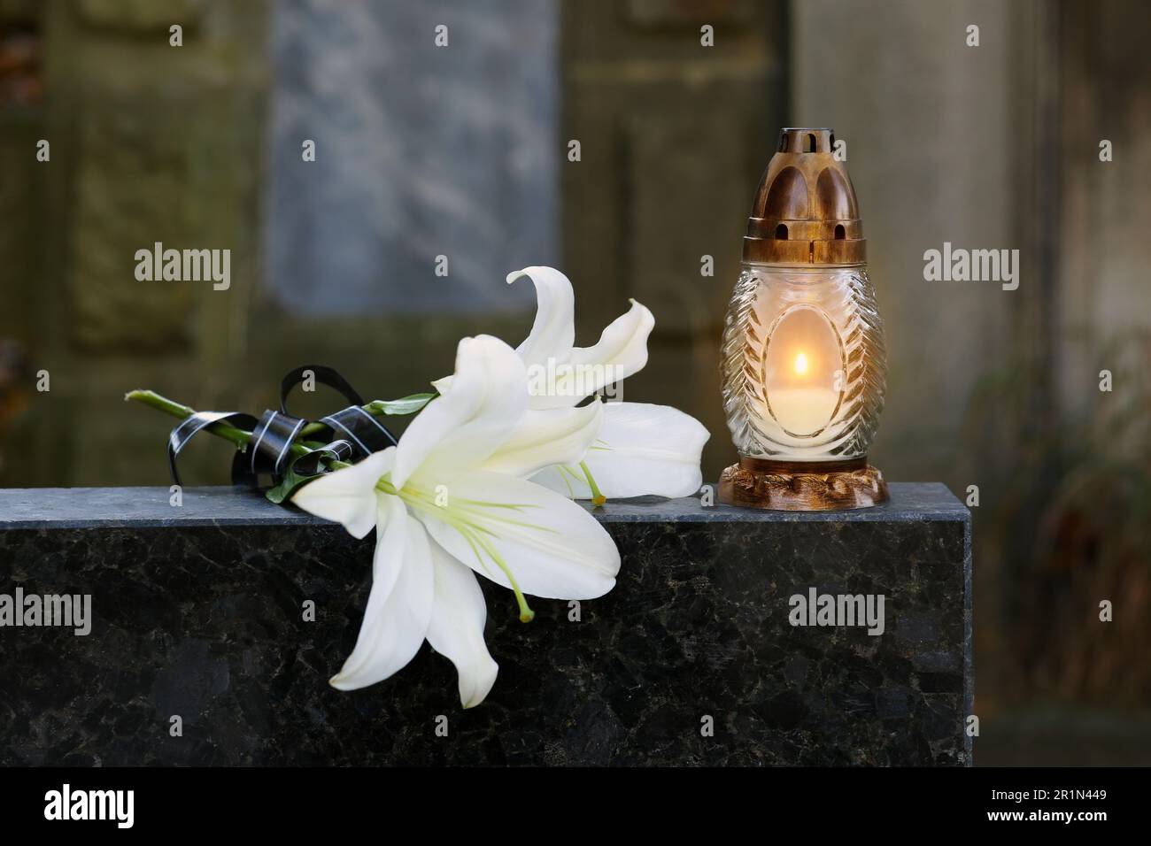 White lilies and grave lantern on tombstone in cemetery Stock Photo - Alamy