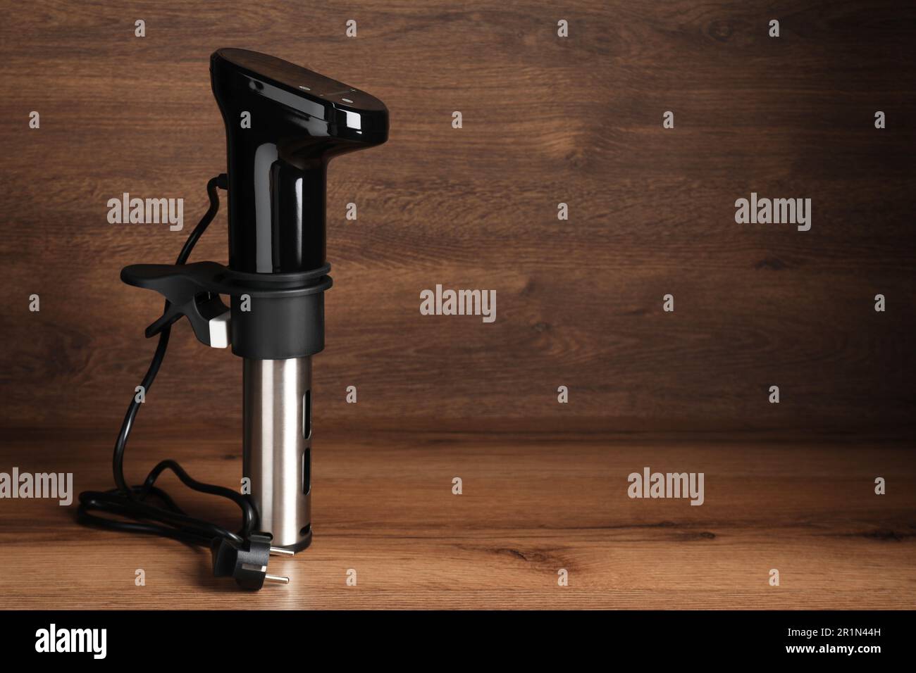 Thermal immersion circulator on wooden table, space for text. Sous vide ...