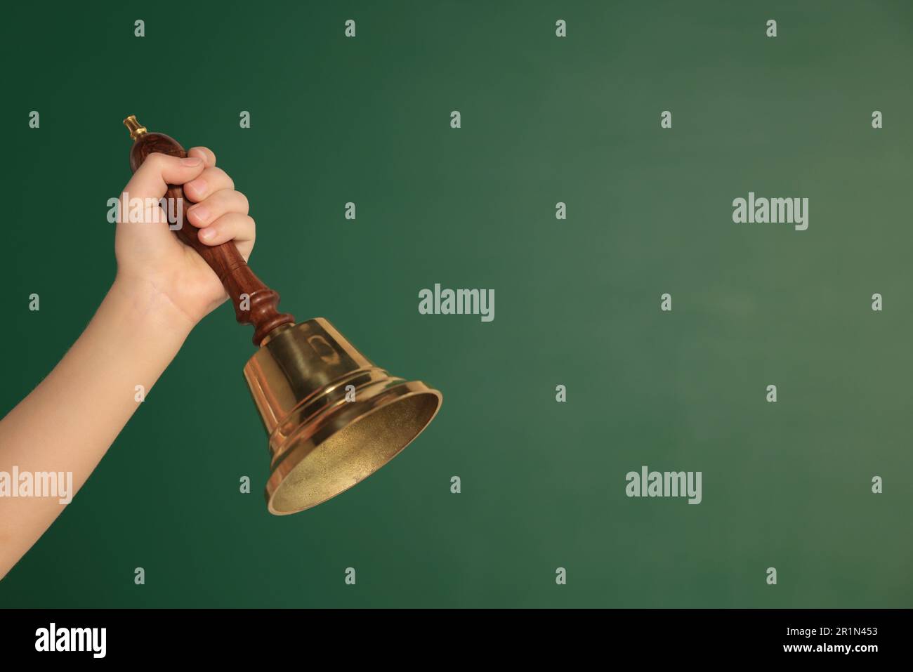 Pupil with school bell near chalkboard, closeup. Space for text Stock ...