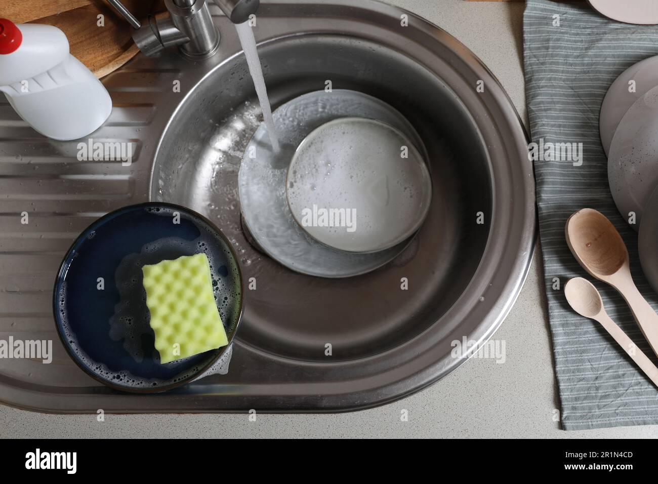 Washing plates in kitchen sink, above view Stock Photo - Alamy