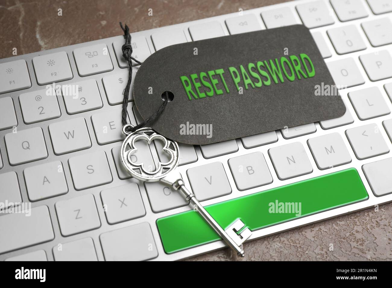 Vintage key with tag on laptop, closeup. Password security concept ...