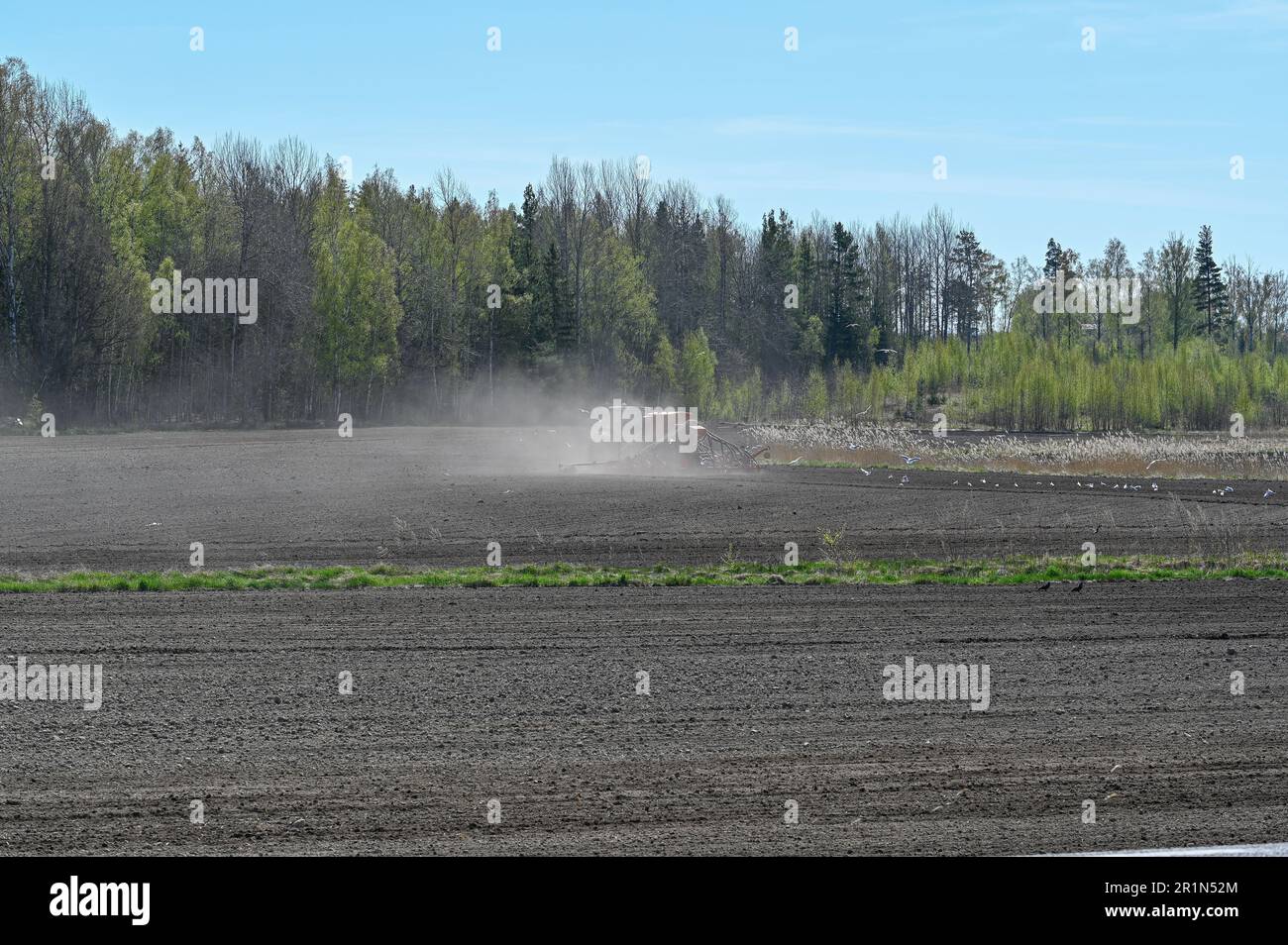 Springtime in farmers field with tractor Orebro Sweden Stock Photo - Alamy
