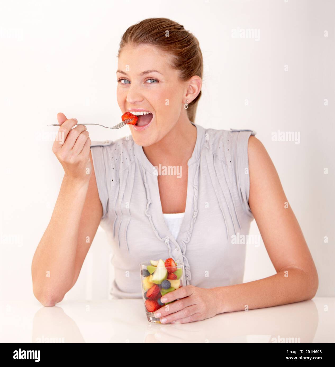 Happy gorgeous model eating salad hi-res stock photography and images ...