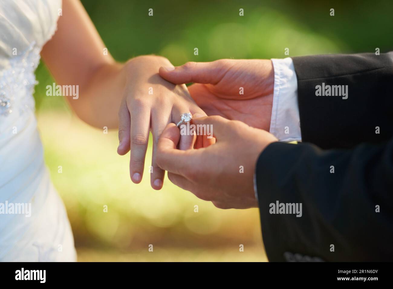 Closeup, wedding and hands with a ring, love ceremony and commitment ...