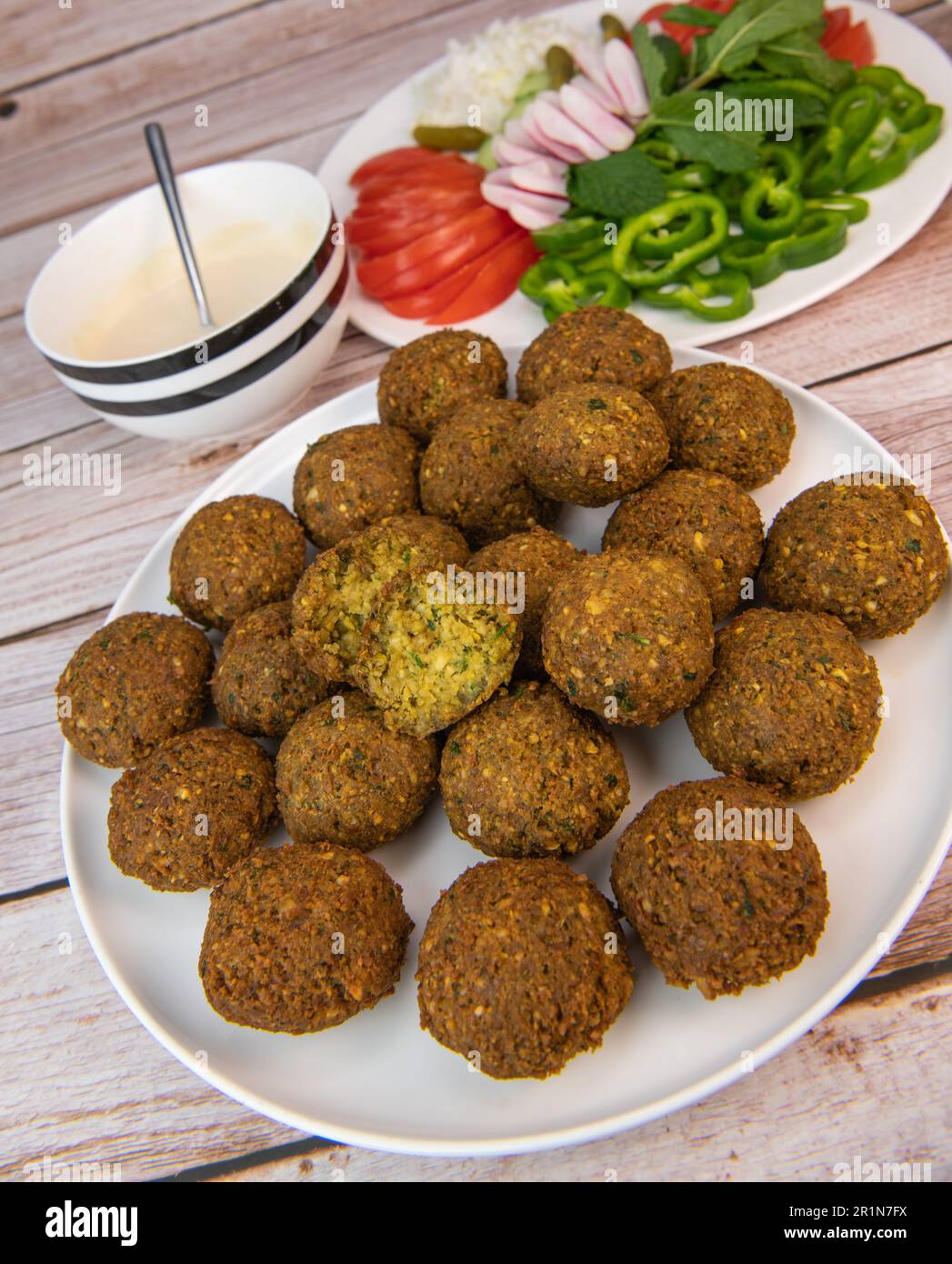 Fried falafel balls and tahini sauce with chopped legumes and chickpeas ...