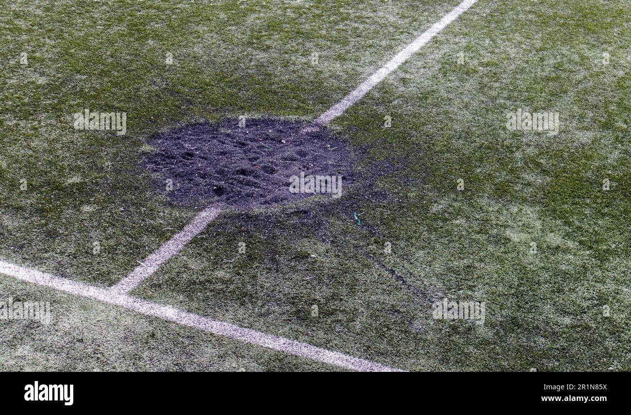 A hole in the ground from a cannon shell explosion filled with fresh ...