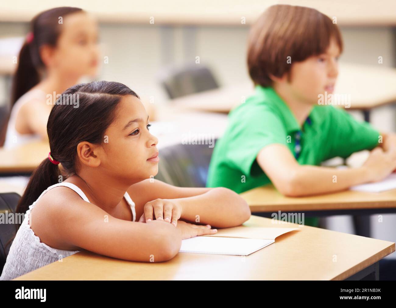 Education, students and girl in classroom with focus, attention and ...