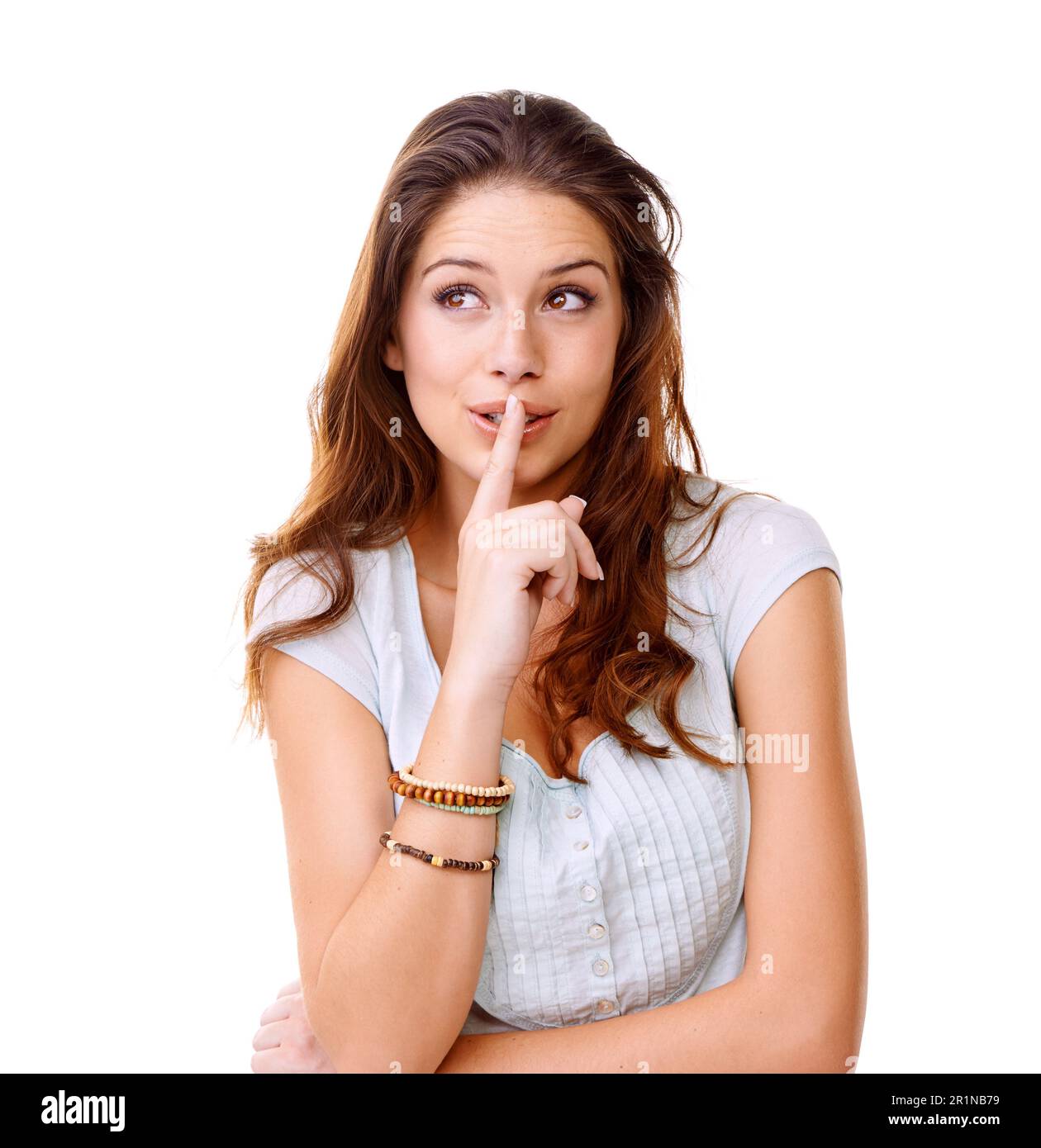 Secret, face and woman with lips on finger in studio, isolated white ...