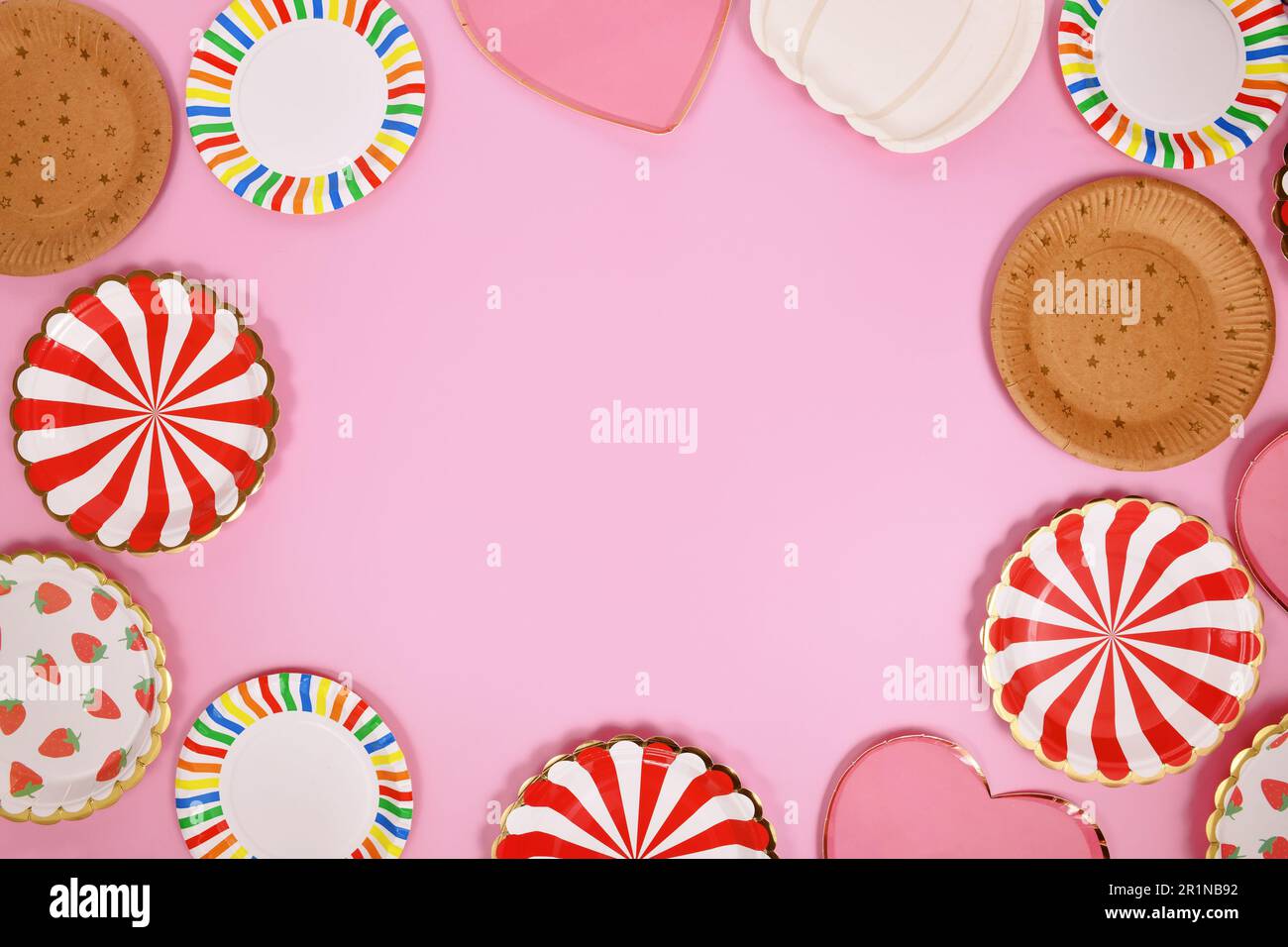 Colorful paper party plates forming border around pink background Stock ...