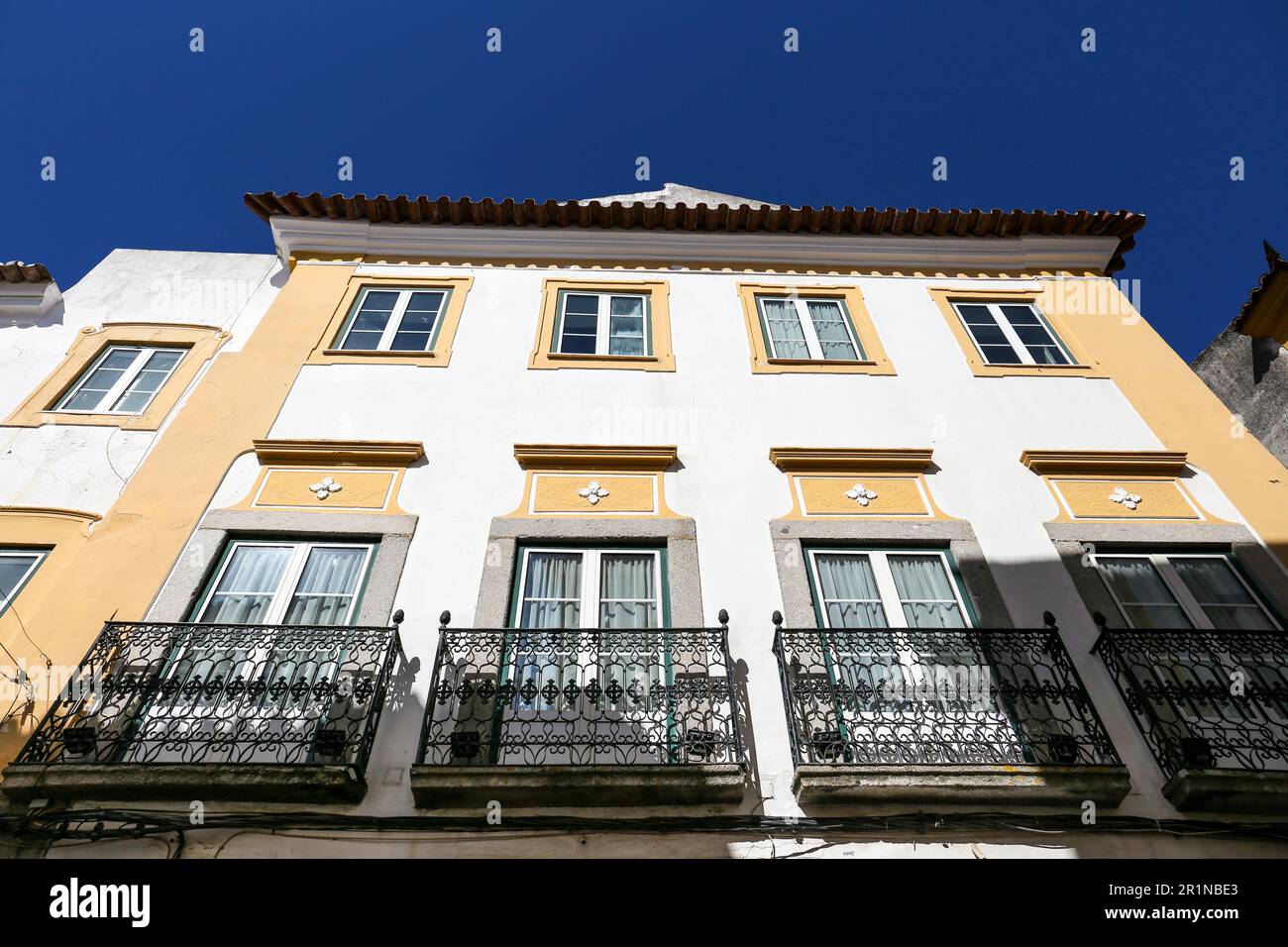 Typical Portuguese facade with beautiful balconies in Evora town ...