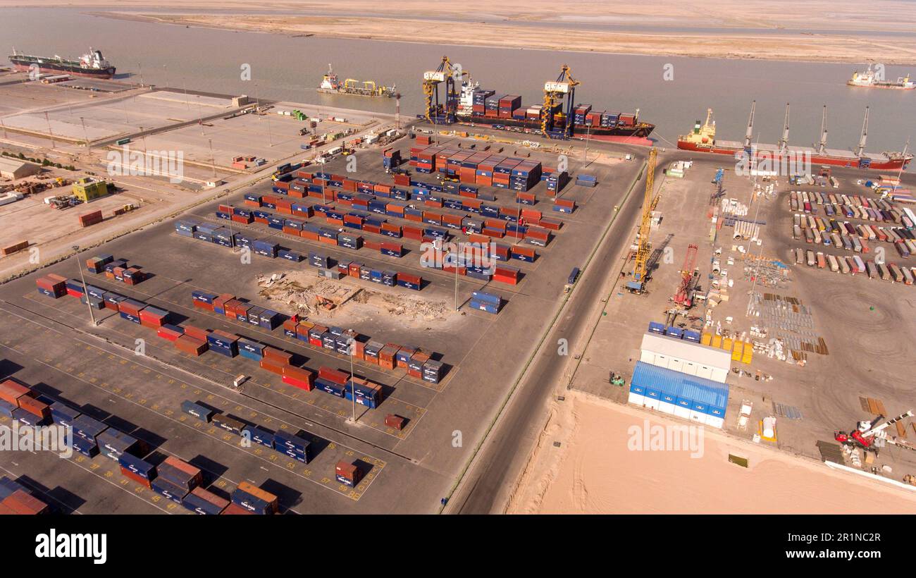 This aerial photo shows containers and moored boats at the port of Umm ...