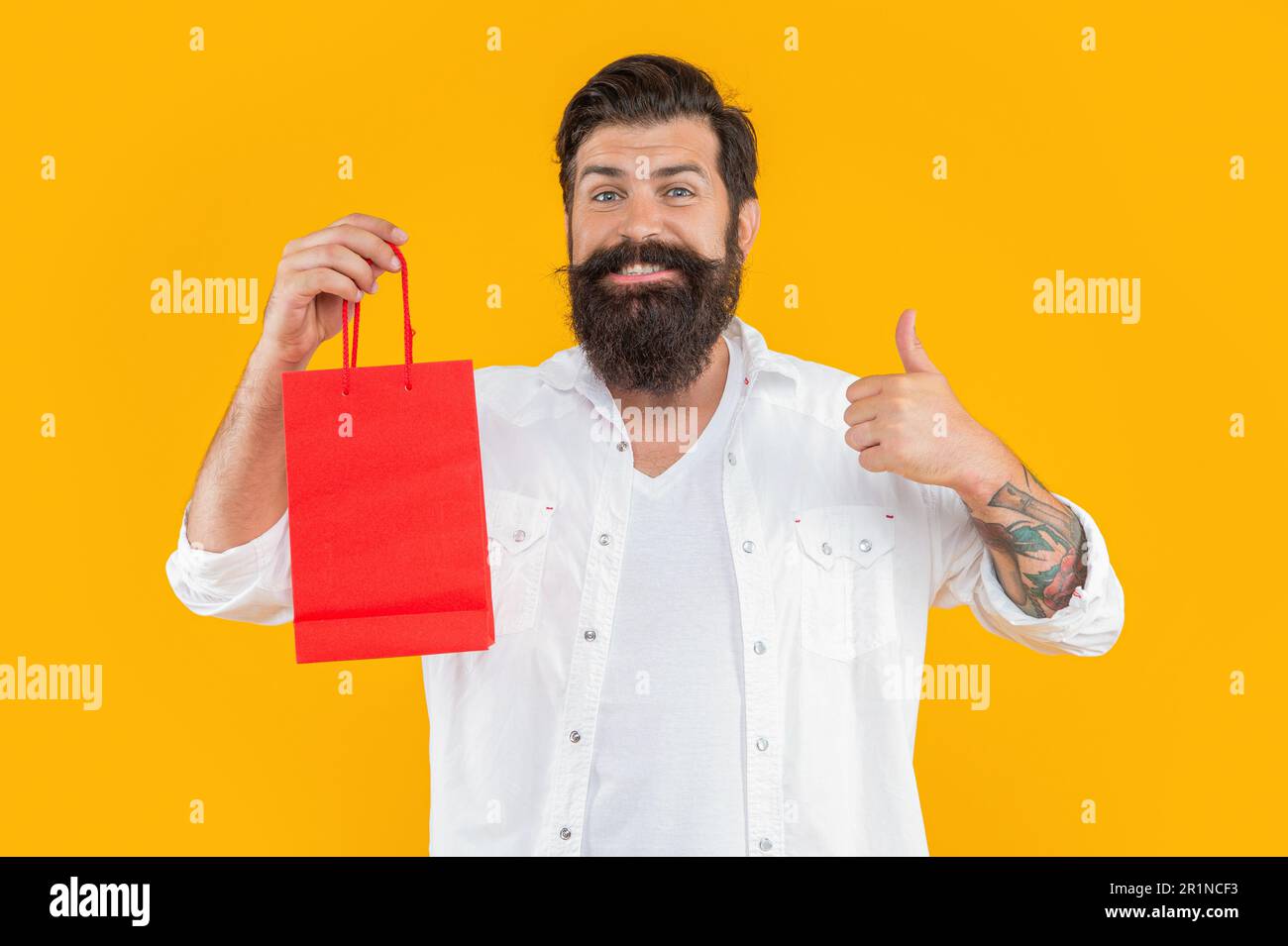 shopper man at shopping on background, thumb up. photo of shopper man ...