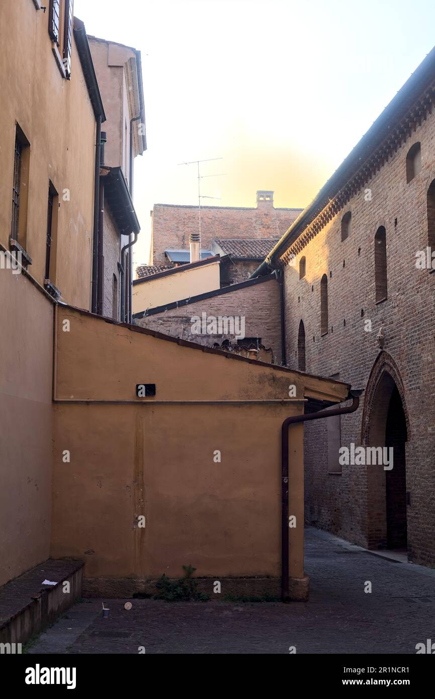 Narrow alley in the shade between historic buildings in an italian town ...