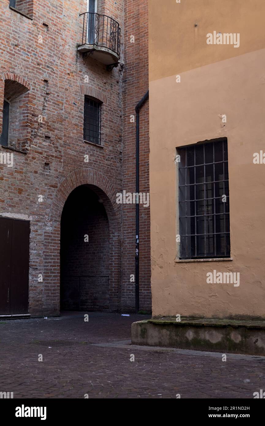Narrow alley in the shade between historic buildings in an italian town ...