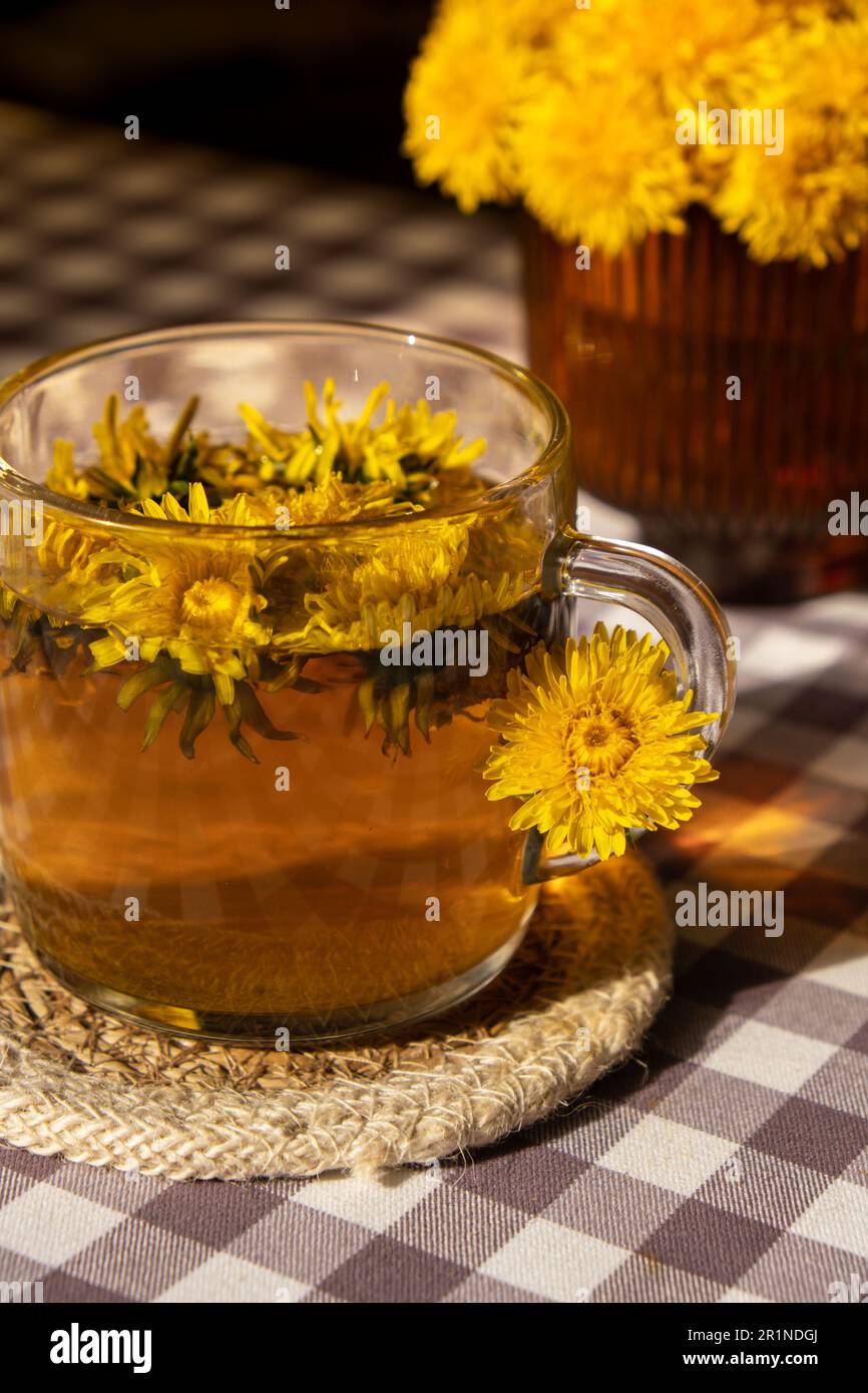 Dandelion flower healthy tea in glass cup on table. Herbal medicine ...