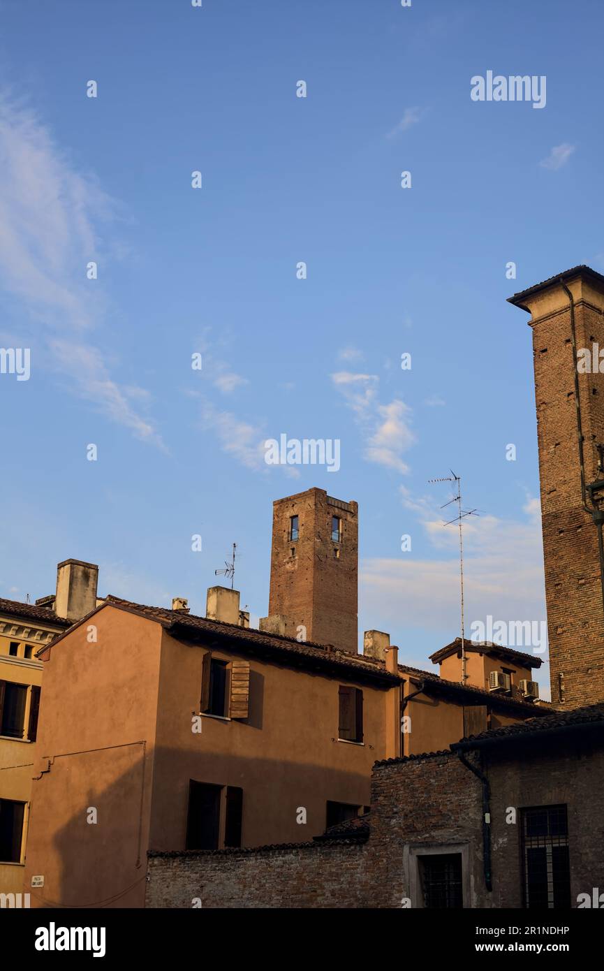 Buildings and a tower in the distance at sunset Stock Photo - Alamy