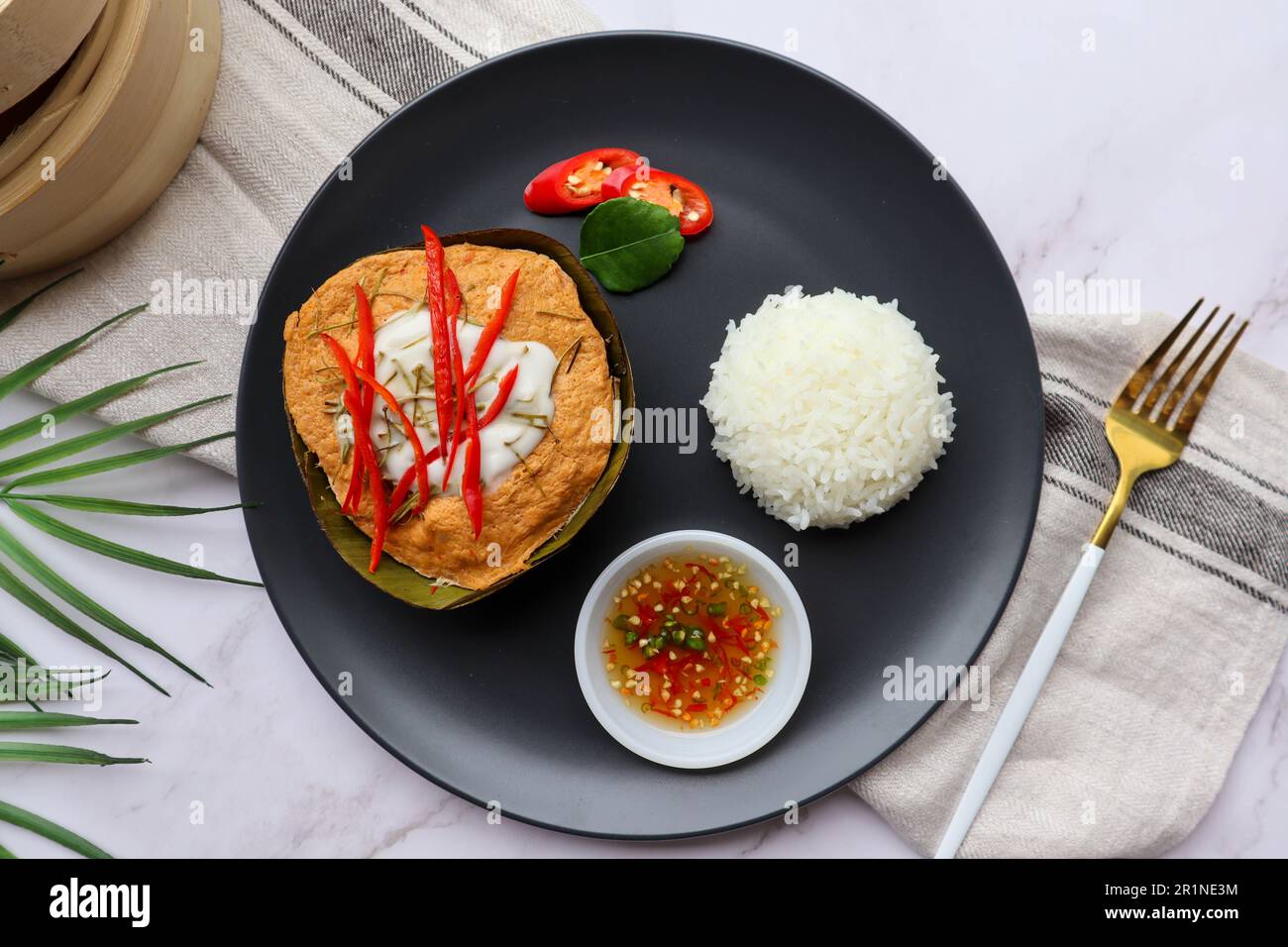 Steamed fish curry in banana leaf cups served with white rice - Famous ...