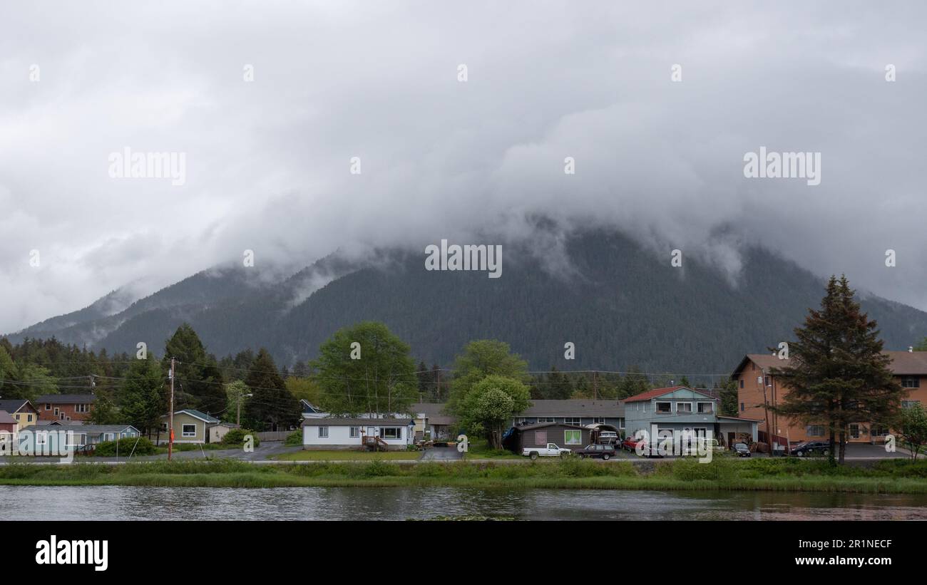 Mountain village on river bank. Misty mountain landscape. Scenic ...