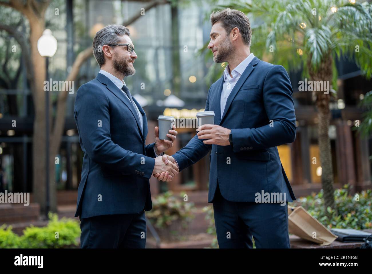 photo of two business partners dealing negotiation. two business ...
