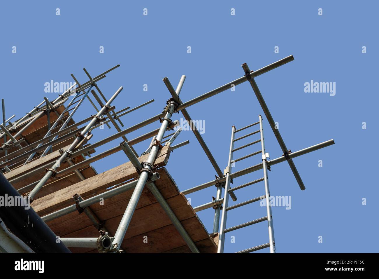 Ladders, planks and metal tubeing, A scaffolding set up allowing acess ...