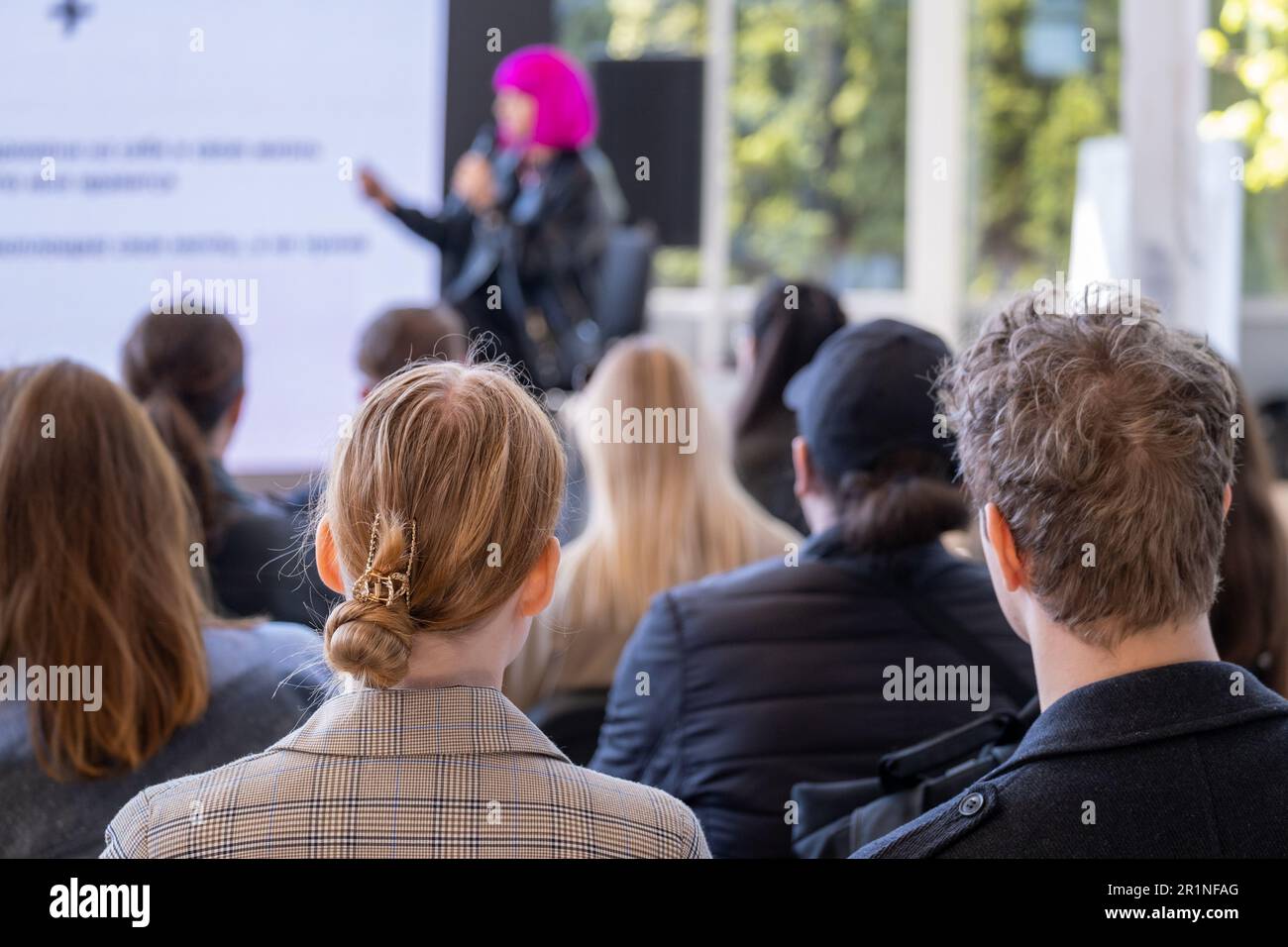 Back view of unrecognizable male and female participants sitting in ...