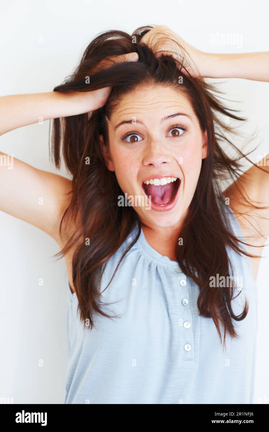 Portrait, surprise and woman touching her hair in studio isolated on a ...